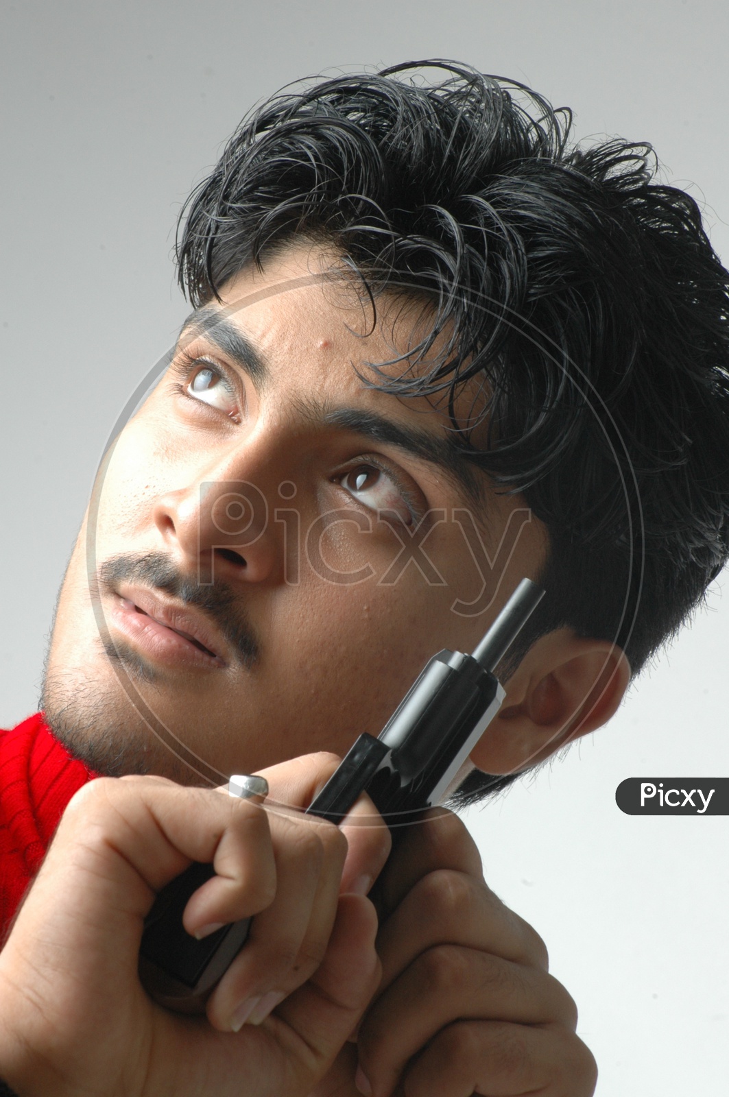 Image of A Young Indian Man Holding Gun And Posing On an Isolated White ...