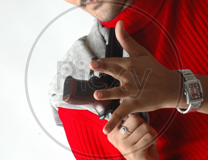 Image of A Young Indian Man Holding Gun And Posing On an Isolated White ...