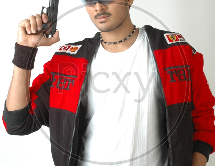 Image of A Young Indian Man Holding Gun or Pistol And Posing On an ...