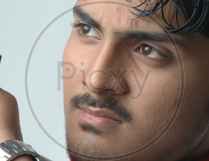 Image of A Young Indian Man Holding Gun And Posing On an Isolated White ...
