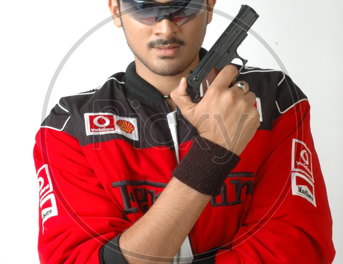 Image of A Young Indian Man Holding Gun or Pistol And Posing On an ...