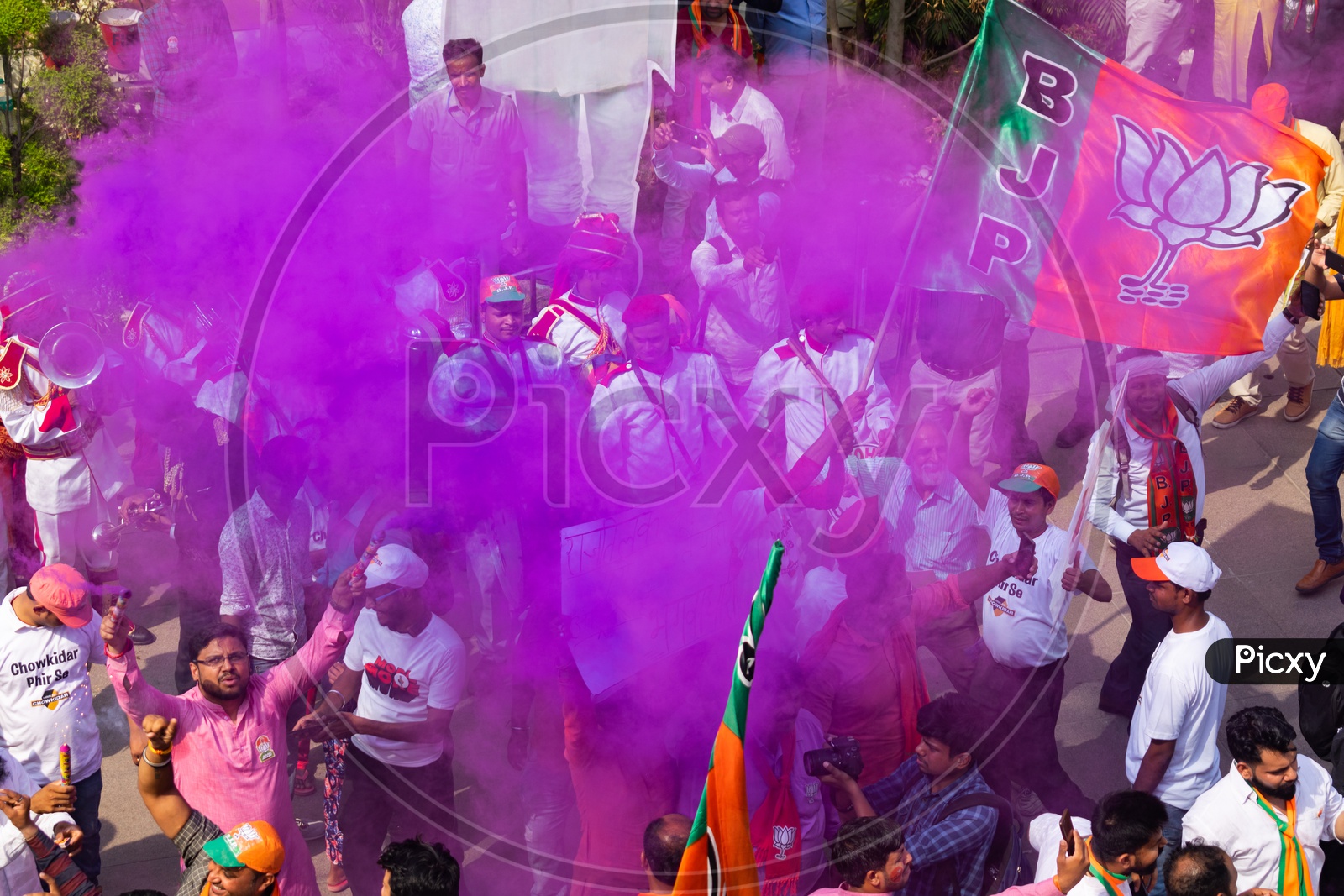 Image of People using color smoke cans and holing flags of Bhartiya Janta Party(BJP)-XF455266-Picxy