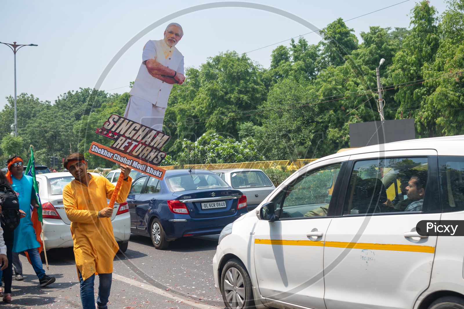 Image of Man holding a banner to support Narendra Modi-LW616041-Picxy