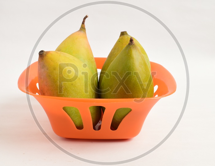 Image of Totapuri or Collector mangoes in a basket.-GR668751-Picxy
