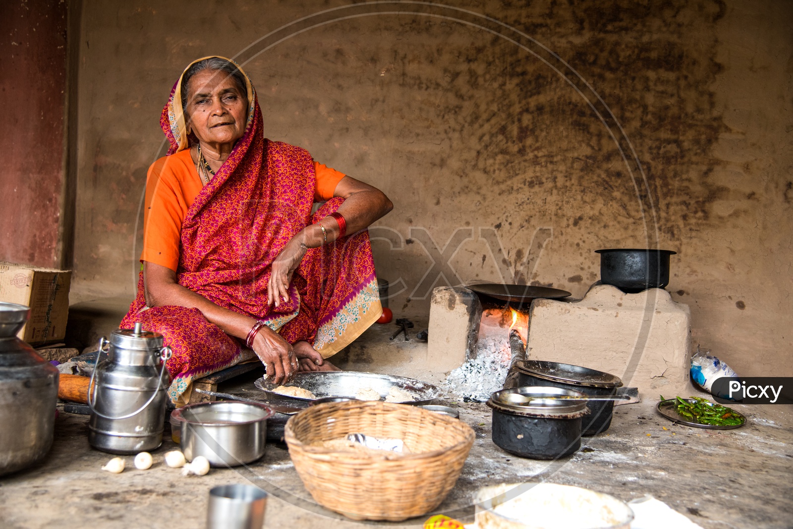 Image of An Indian Old Woman Making Or Cooking Food In an Ancient Or ...