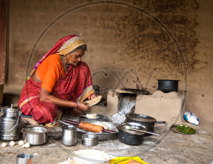 Image of An Indian Old Woman Making Or Cooking Food In an Ancient Or ...