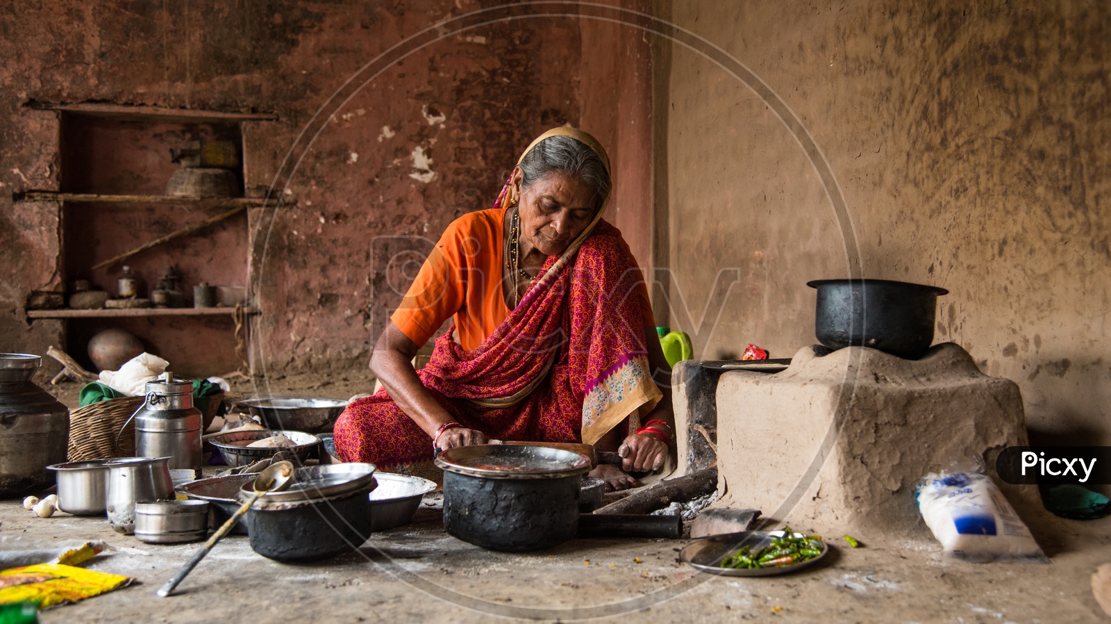 Image of An Indian Old Woman Making Or Cooking Food In an Ancient Or ...