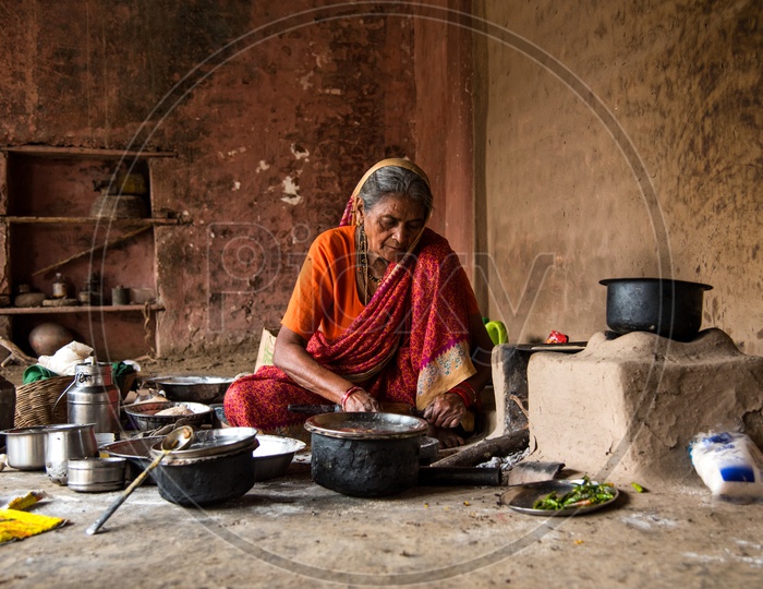 Image of An Indian Old Woman Making Or Cooking Food In an Ancient Or ...