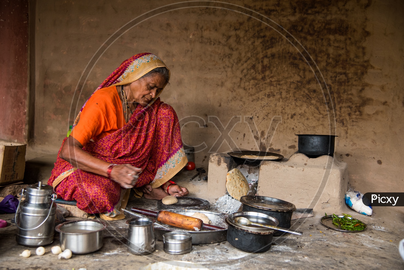 Image of An Indian Old Woman Making Or Cooking Food In an Ancient Or ...