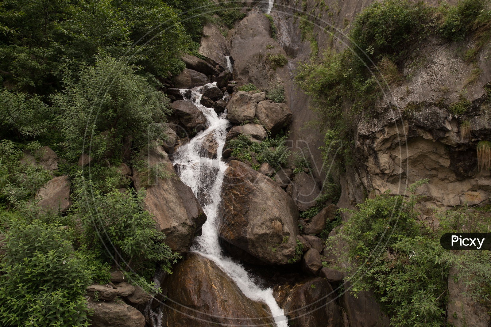 Image of Water Falling From Hill Top and Through Stones in a Valley ...