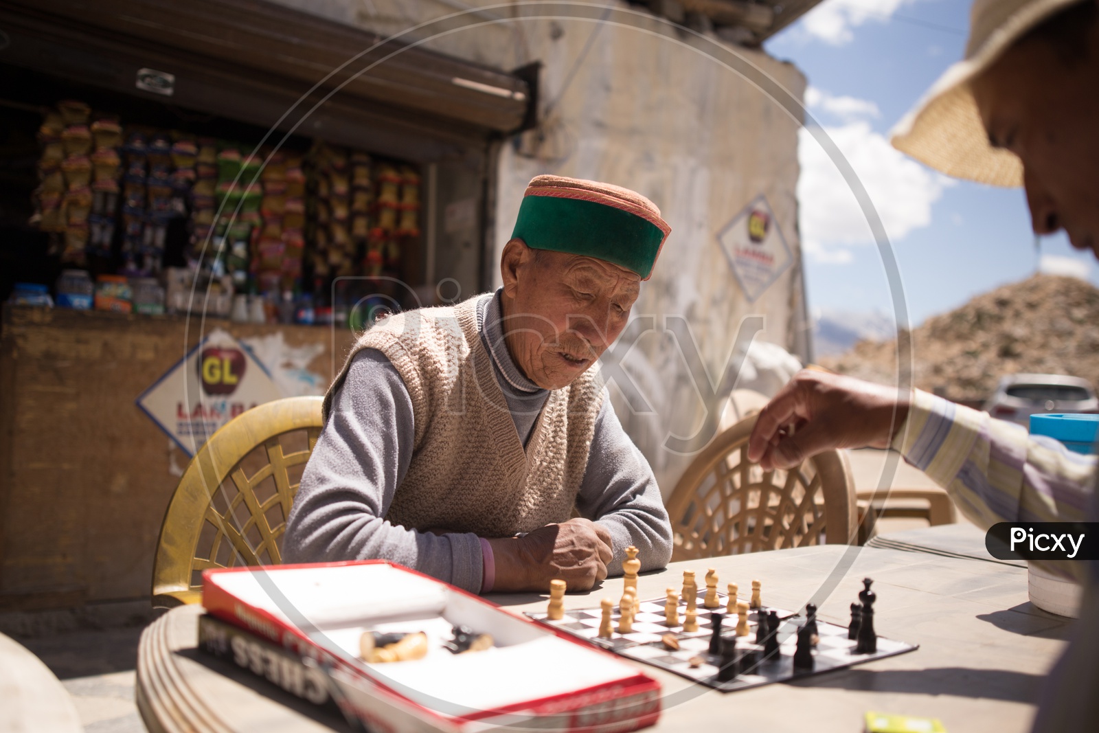 Image of Villagers Playing Chess By Sitting At a Eatery Shop In A ...