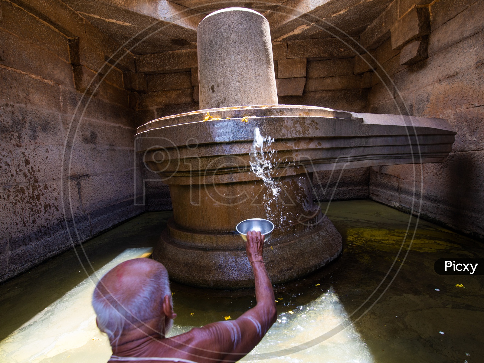 Image of A Priest Performing Pooja For the Badavi Linga Statue ...