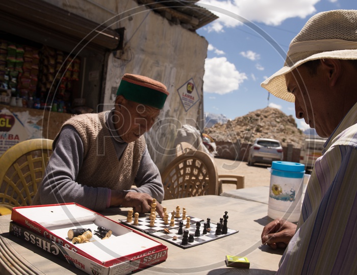 Image of Villagers Playing Chess By Sitting At a Eatery Shop In A ...