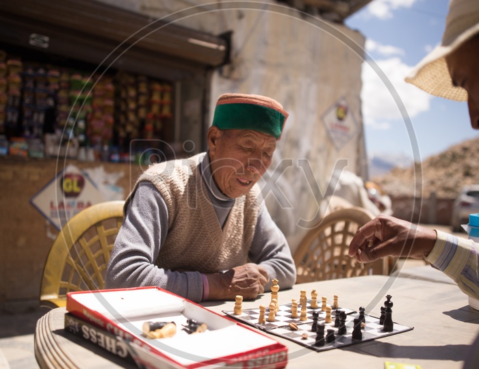 Image of Villagers Playing Chess By Sitting At a Eatery Shop In A ...
