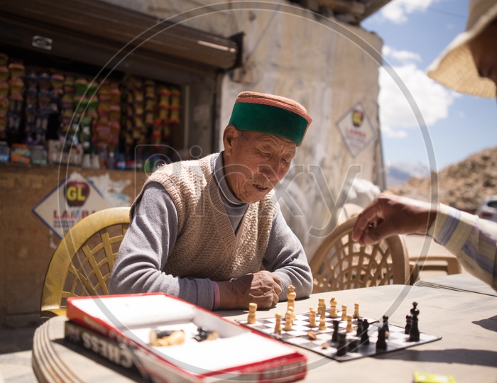 Image of Villagers Playing Chess By Sitting At a Eatery Shop In A ...