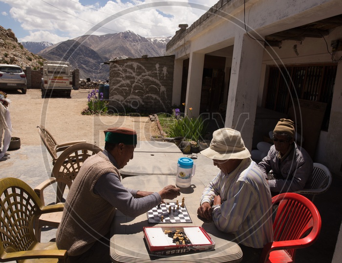 Image of Villagers Playing Chess By Sitting At a Eatery Shop In A ...