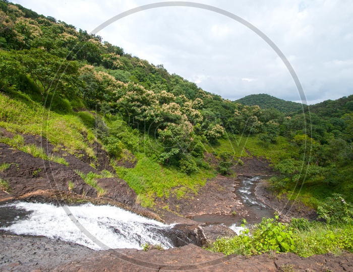 Image of A Landscape With Hills, Trees And River Flowing on Forest ...