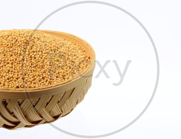 Image of yellow mustard seeds in wooden basket isolated on white ...