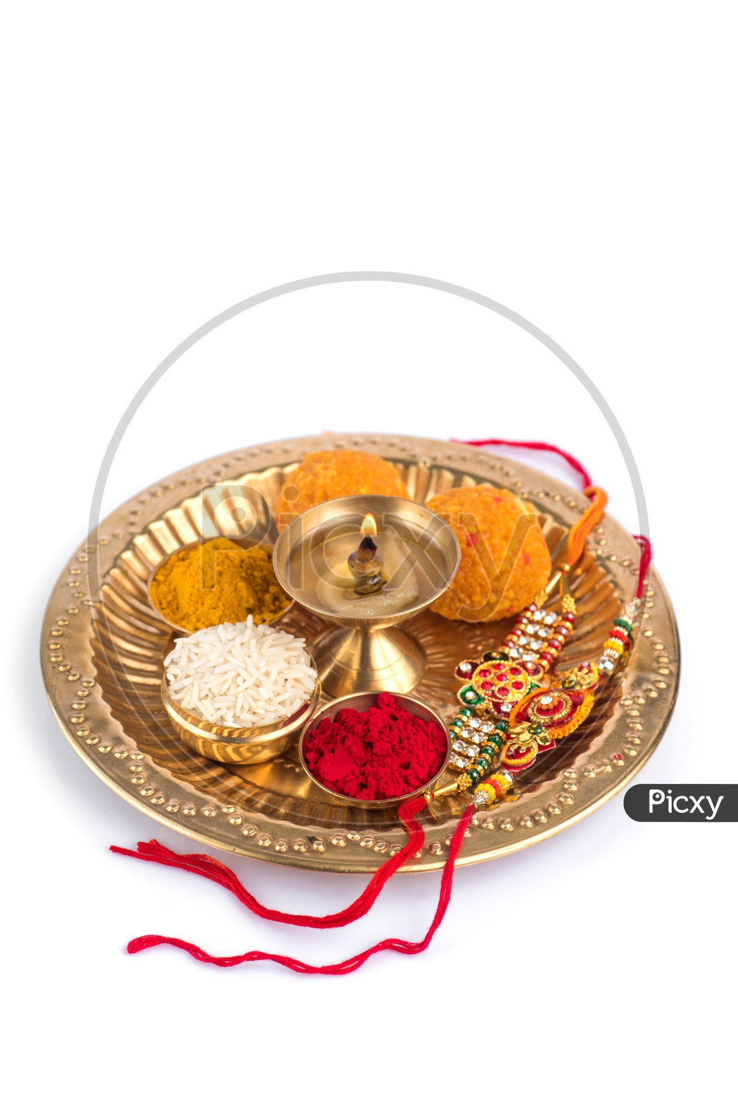 Image of An Elegant Rakhi On an Pooja Thali With Rice Grains,Kumkum ...