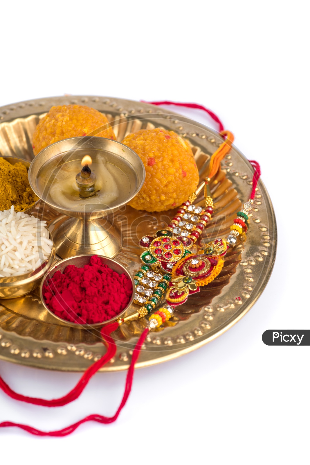Image of An Elegant Rakhi On an Pooja Thali With Rice Grains,Kumkum ...