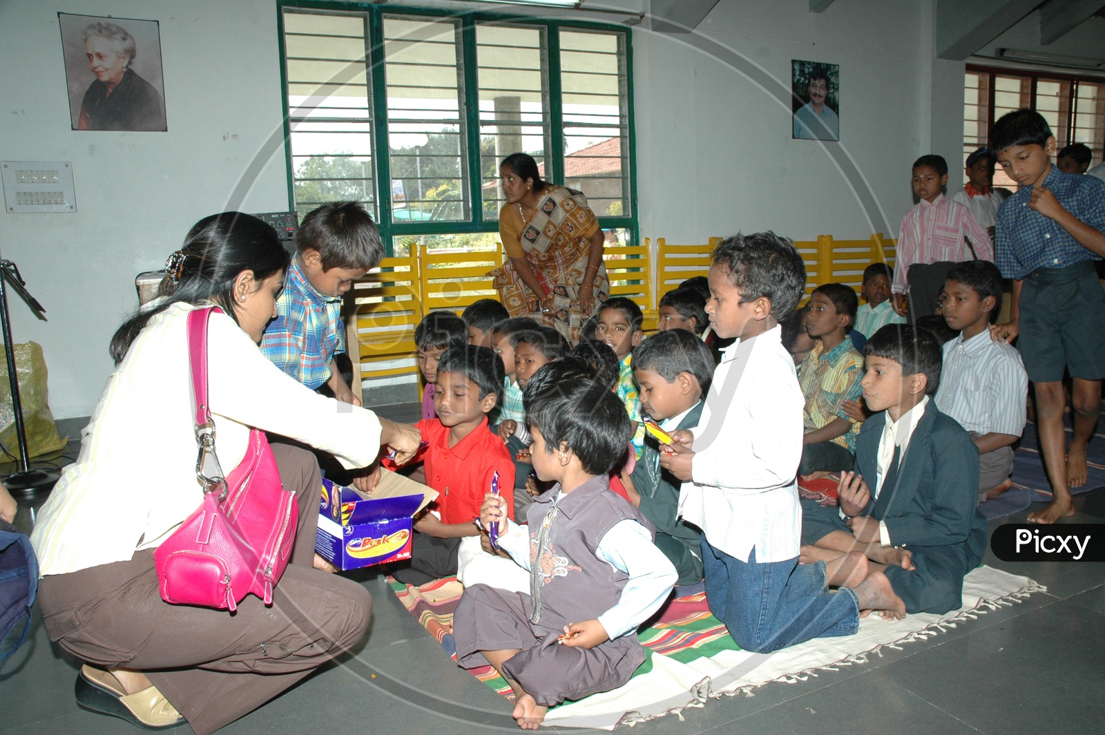 Image of A Couple Distributing chocolates to Kids In a Orphanage Home ...
