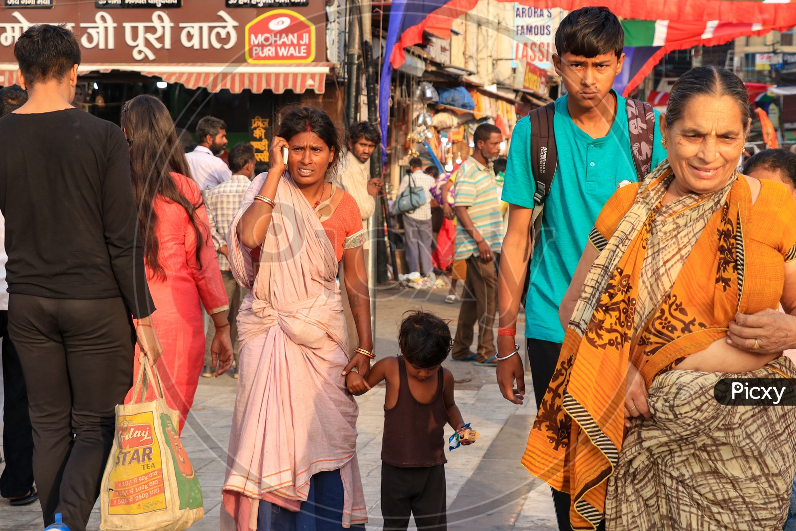 Image of A poor woman talking on mobile phone-IB792804-Picxy