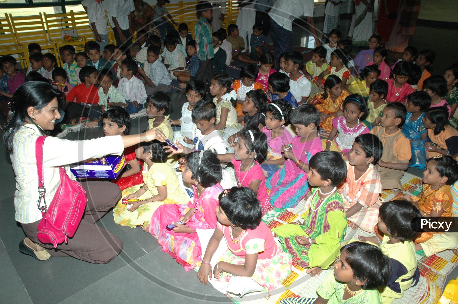 Image of A Couple Distributing Chocolates For Kids-TW083915-Picxy