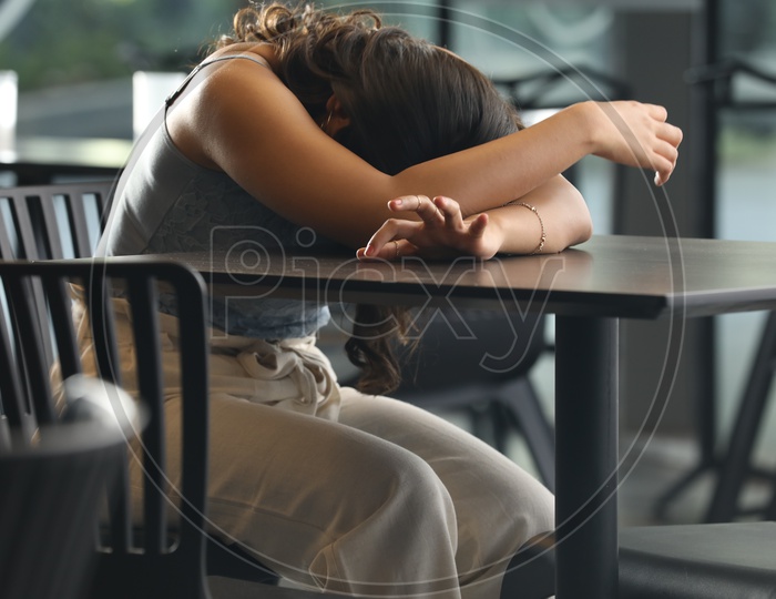 Image of Young Girl Lying Head On Table or Unhappy Or Uneasy Girl ...