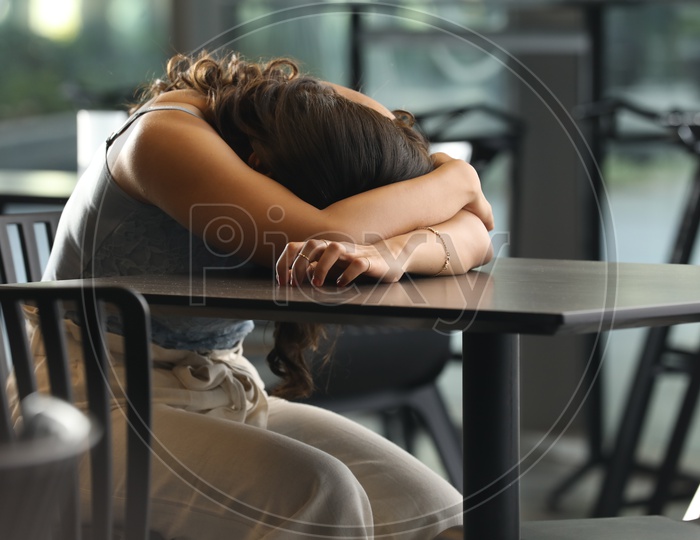 Image of Young Girl Lying Head On Table or Unhappy Or Uneasy Girl ...