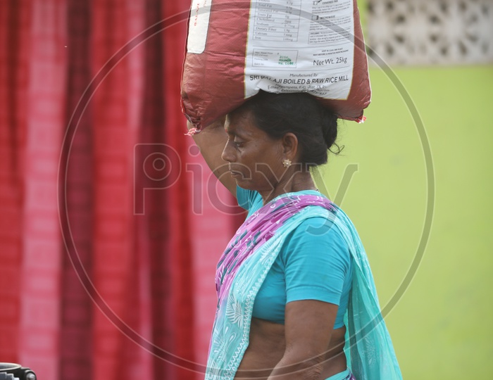 Image of A Rural Indian Woman Carrying The Heavy Weights On Her Head ...