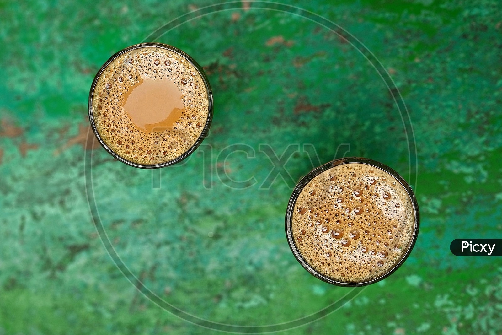 Image of two tea cups top view with green background-BU038490-Picxy