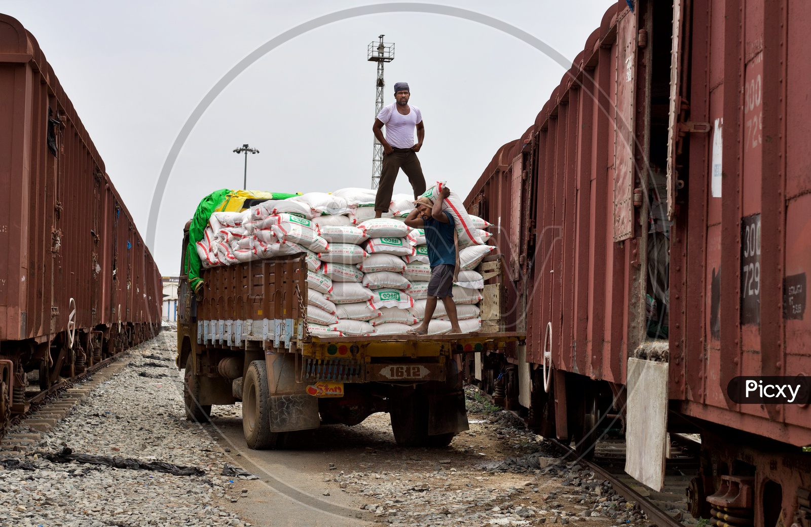 Image of Goods being unloaded from a Goods train.-AR100843-Picxy