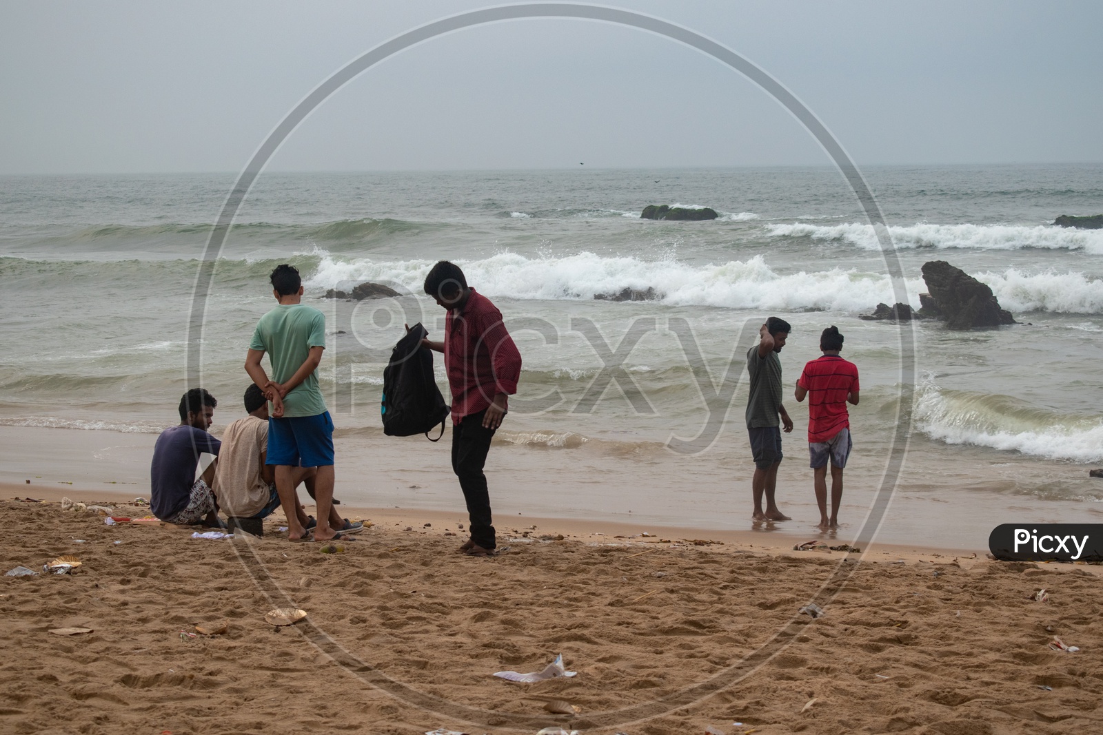 Image of Group of young men enjoying the beach view at Rama Krishna ...