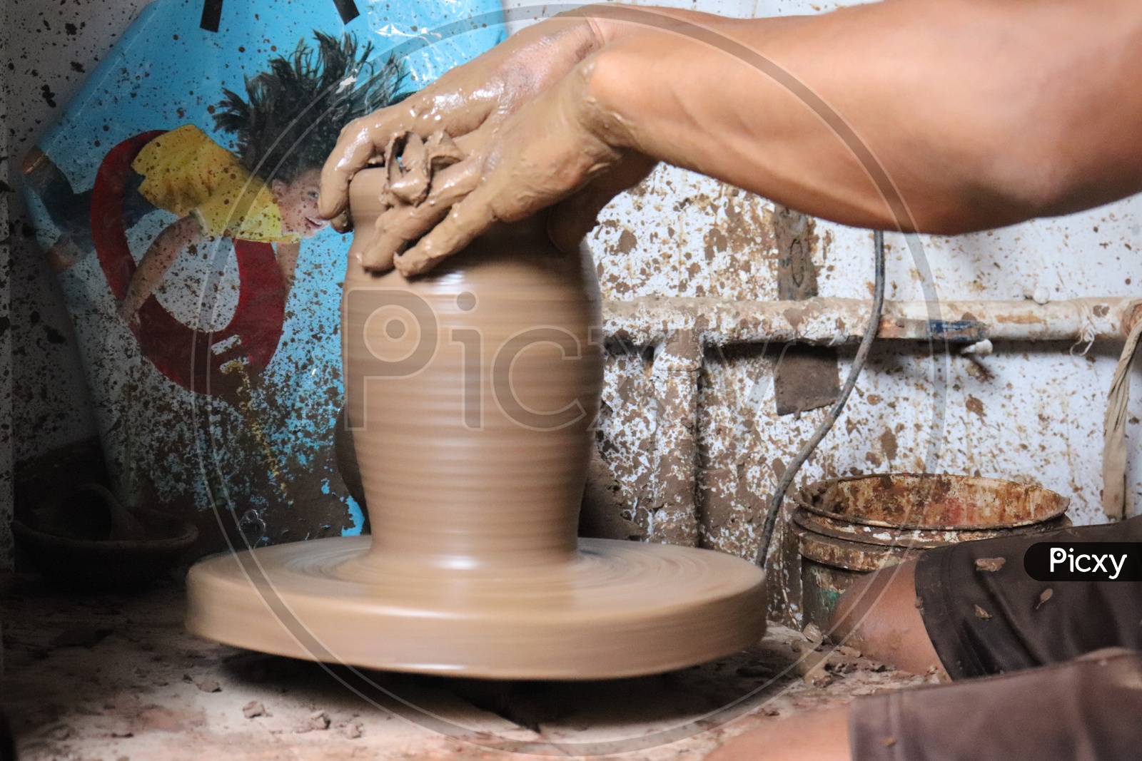 Image of A Professional Potter Making Pots by Turning Potter Wheels ...