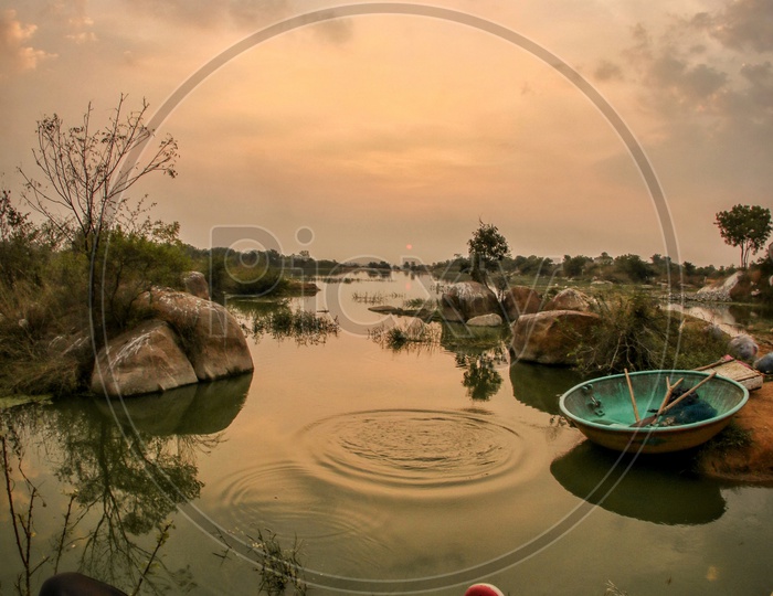 Image of Coracle Boats In a Lake Water With Sunset Sky In Background ...