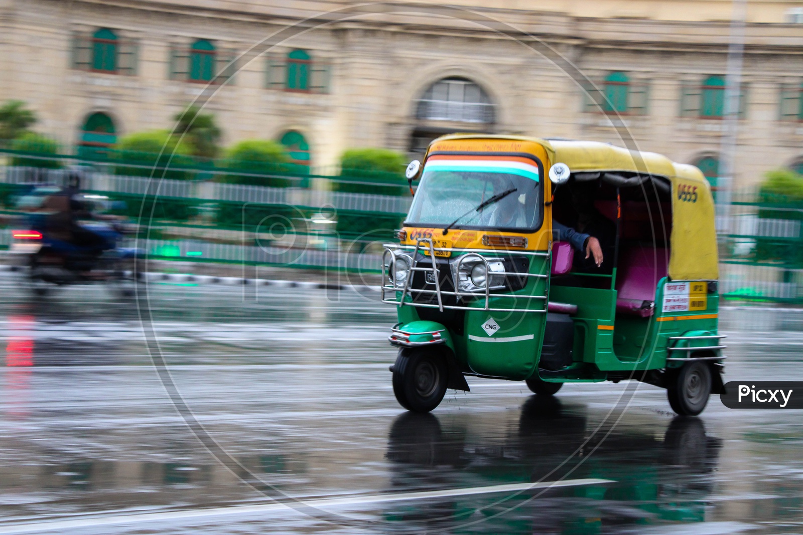 Image of An auto rickshaw on the road after rains-BT794480-Picxy