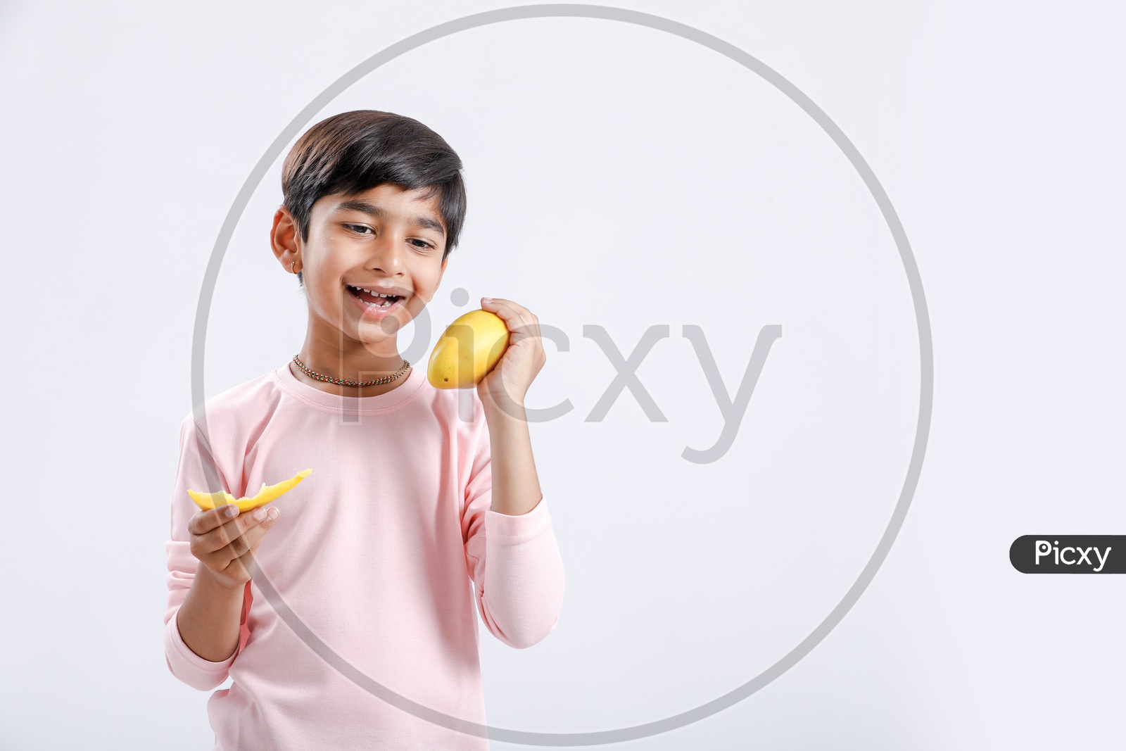 Image of Indian Cute Boy / Asian Boy or kid Enjoying Eating Mango With ...