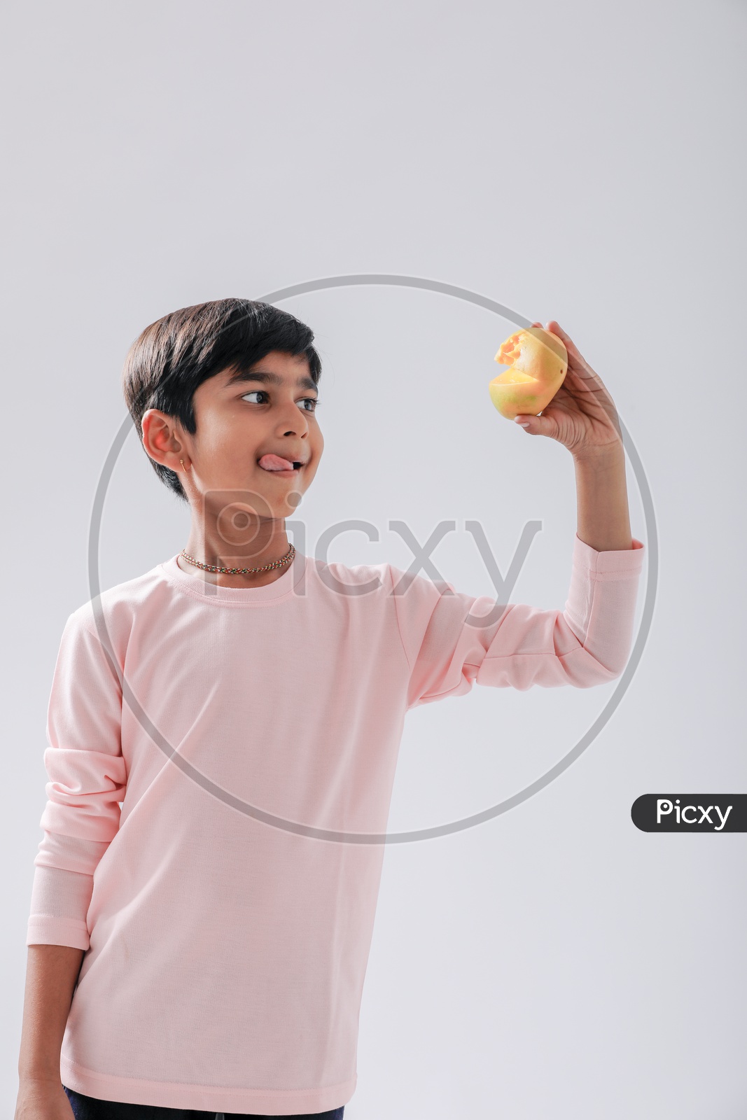 Image of Indian Cute Boy or Asian Boy or kid Holding Mango With an ...