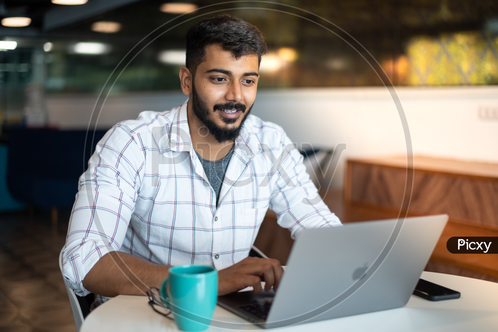 Image of Young man or Indian man Happily Smiling Using Laptop in ...