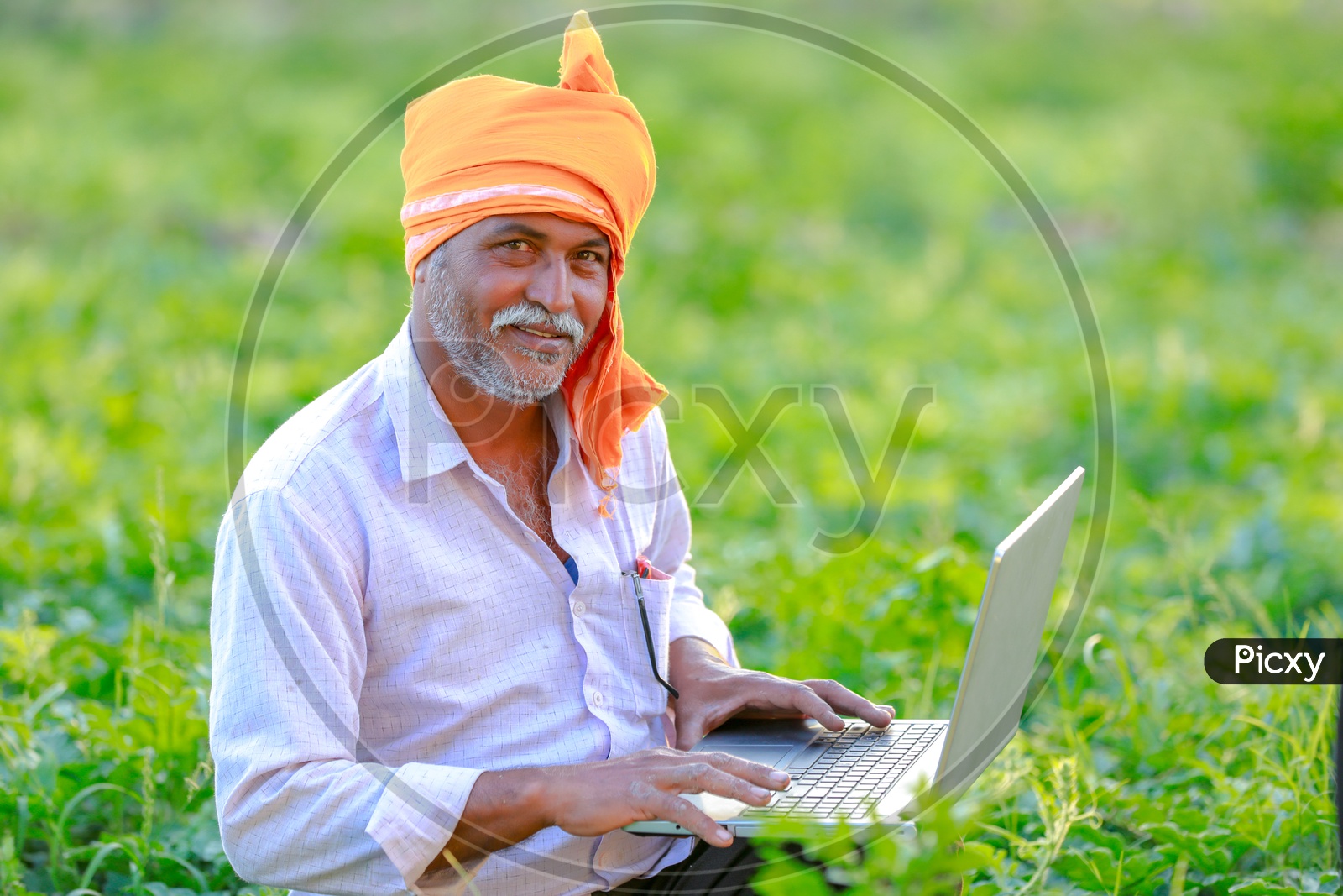 Image of Indian Farmer Using Laptop On Green Farm Fields Background ...