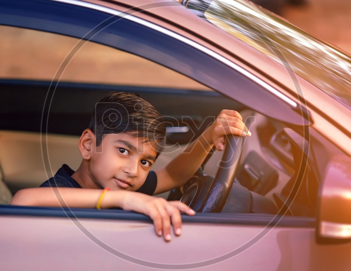 Image of Young Indian Boy or Kid Or Child in Car and Posing-XW643620-Picxy