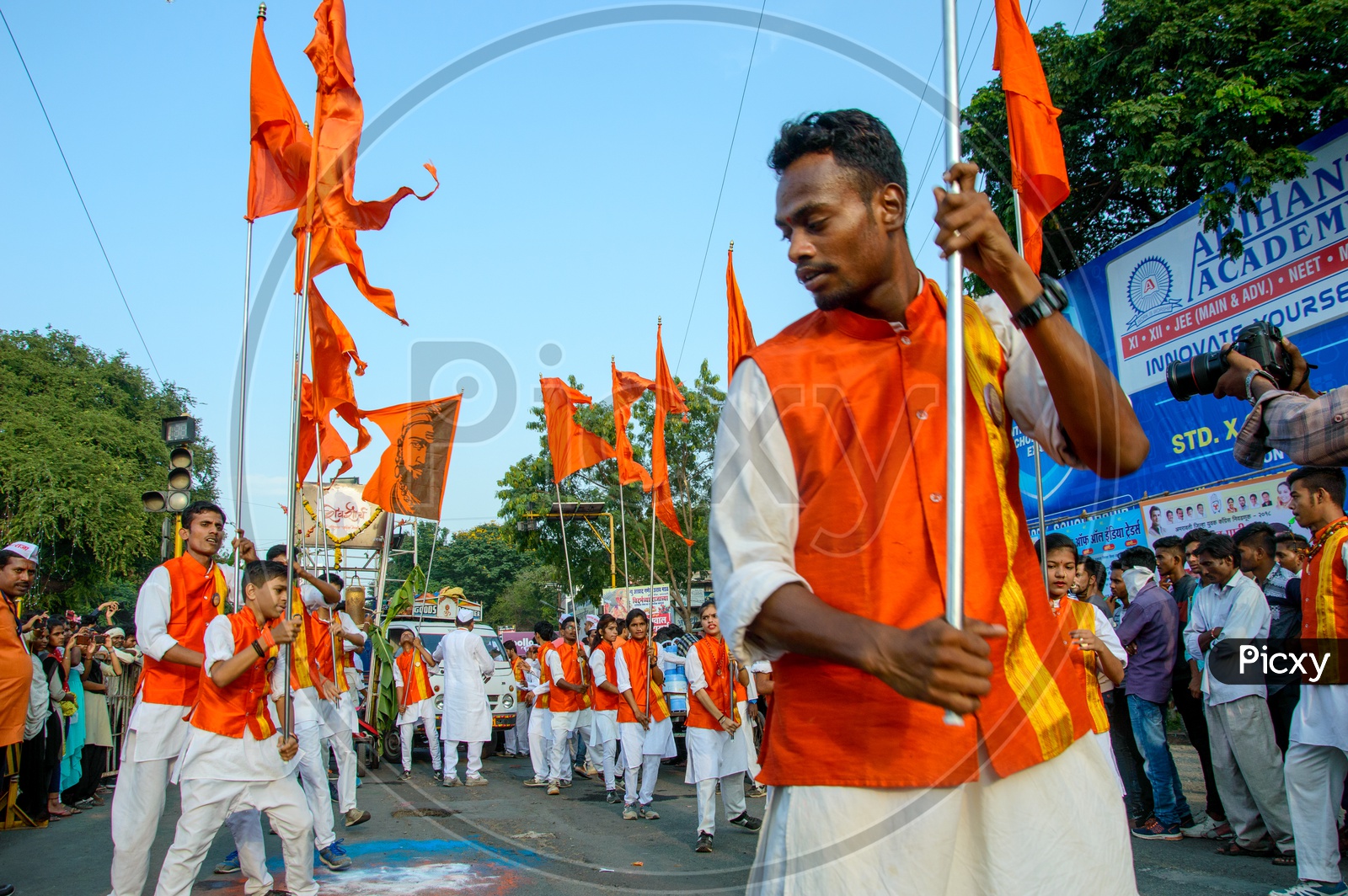 Image of A Group of Man Performing And Dancing On the Streets Holding Saffron Flags During Lord ...