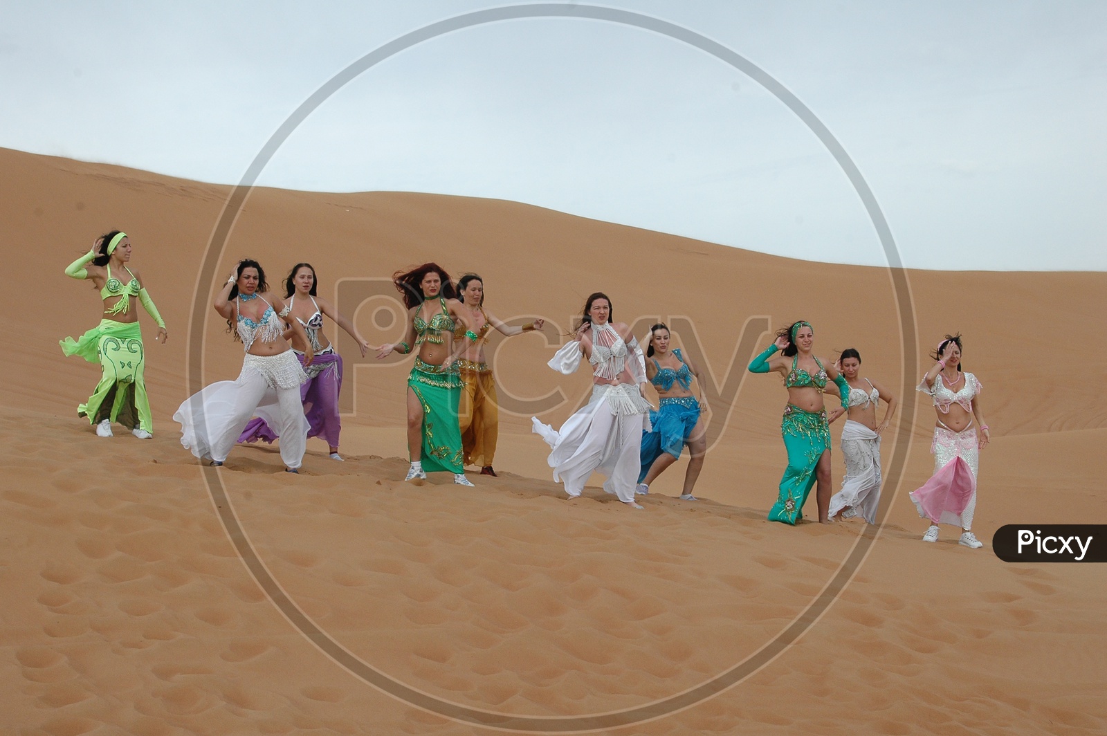 Image of Foreign Dancers Dancing in Desert-BW360545-Picxy