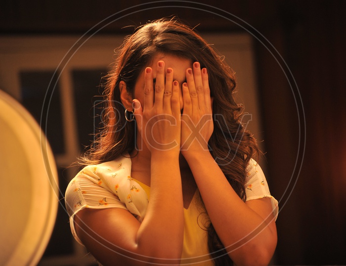 Image of Woman Covering Face With Palms In Shy-DZ023425-Picxy