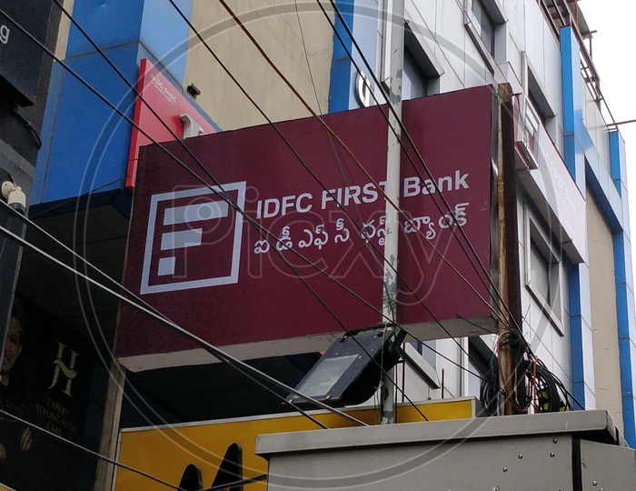 Image of Idfc first bank small flyer logo suspended from a building ...