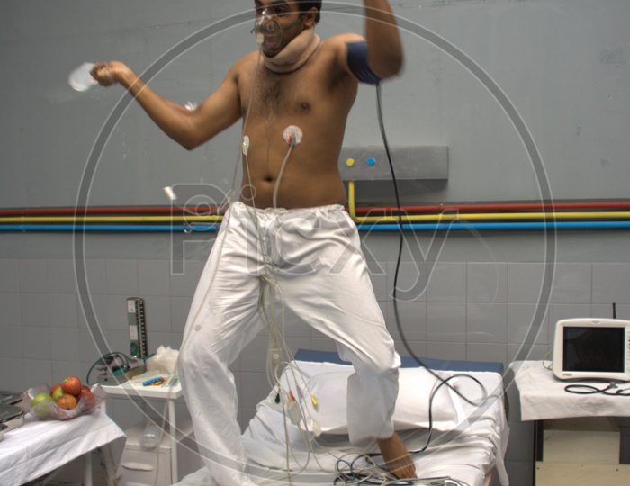 Image of A mad patient standing on a hospital bed-KT521046-Picxy