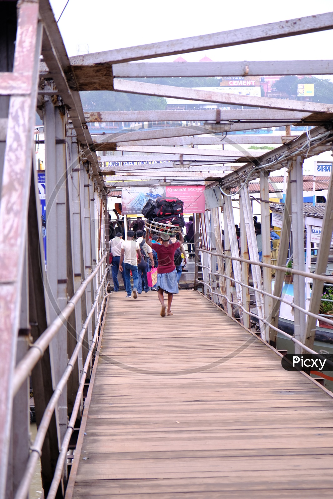 Image of A Porter Carrying Luggage on Foot-over bridge-YU374652-Picxy