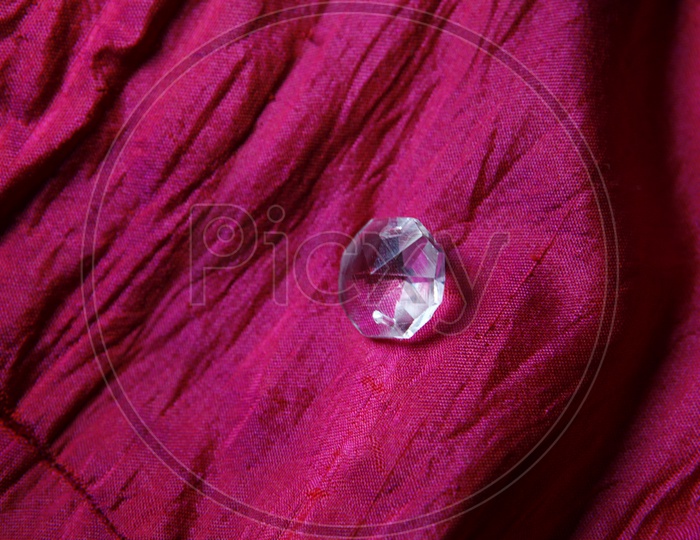 Image of Diamond On a Red Colour Cloth-EW228500-Picxy