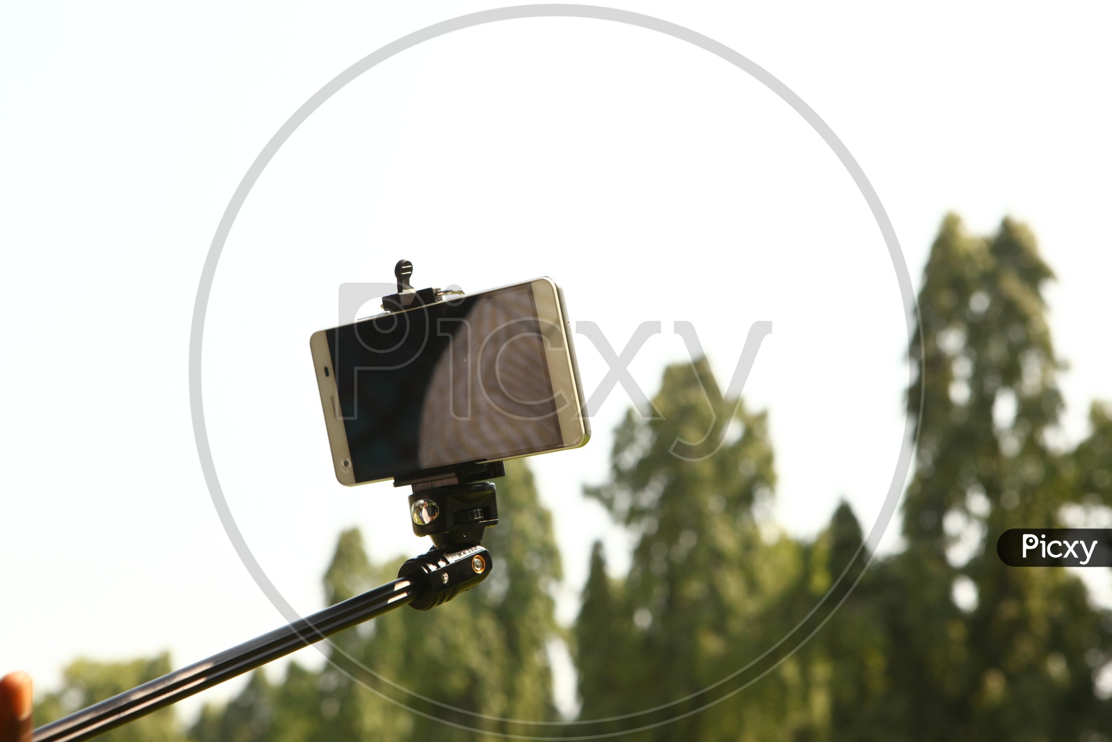 Image of Smart Phone Attached To a Selfie Stick-CG641740-Picxy