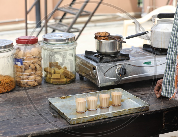 Image of Tea Vendor Preparing Tea Or Chai In a Vendor Stall-EE743388-Picxy